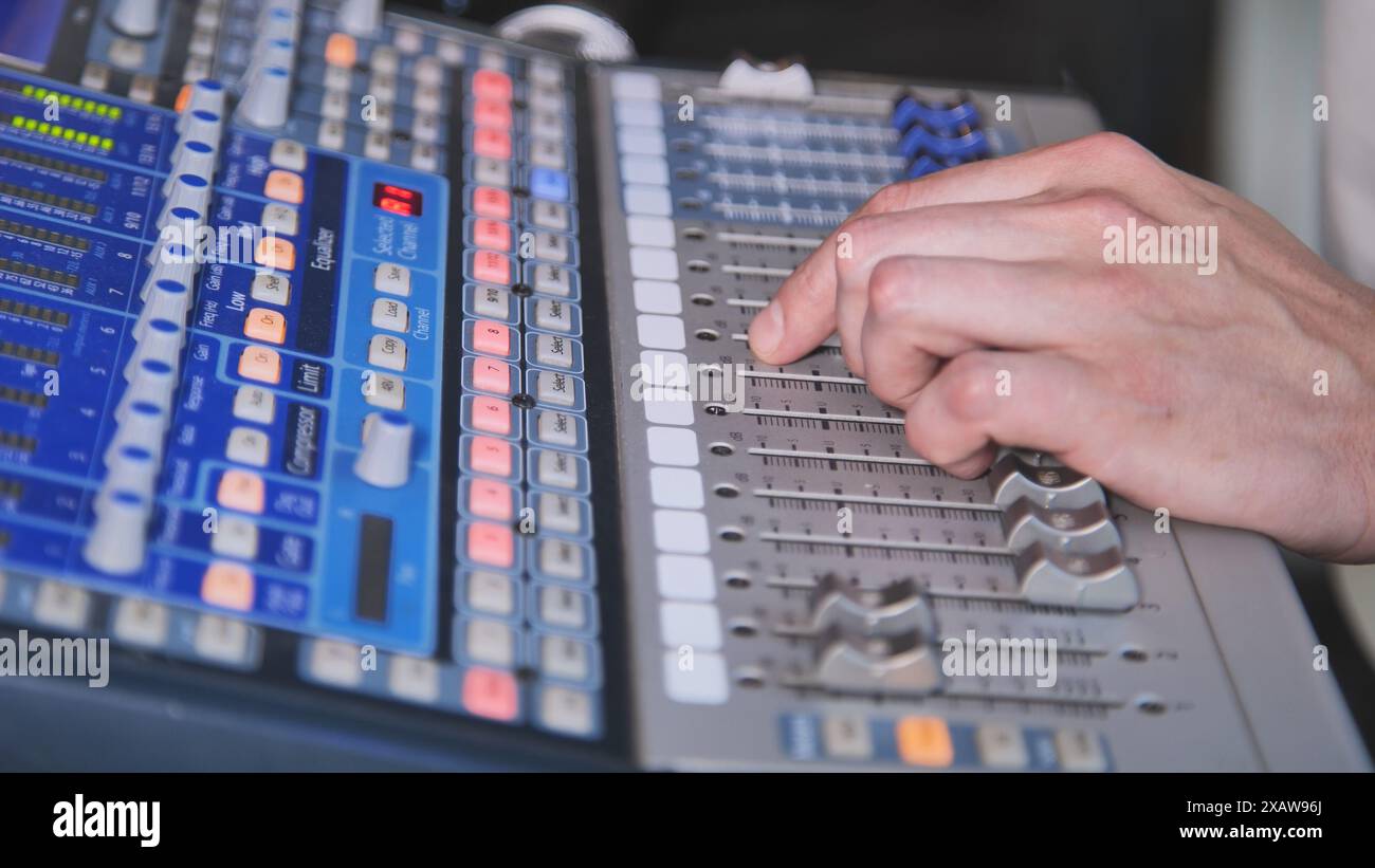 A man operates a mixing console Stock Photo - Alamy