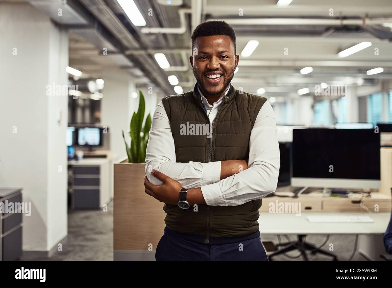 Portrait, intern and black man in office with arms crossed, smile and confidence. Startup ...