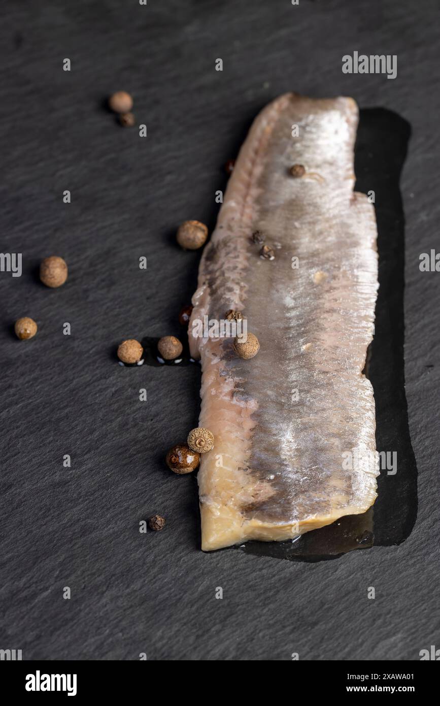 salted herring fillet on the table, delicious salted herring marinated ...