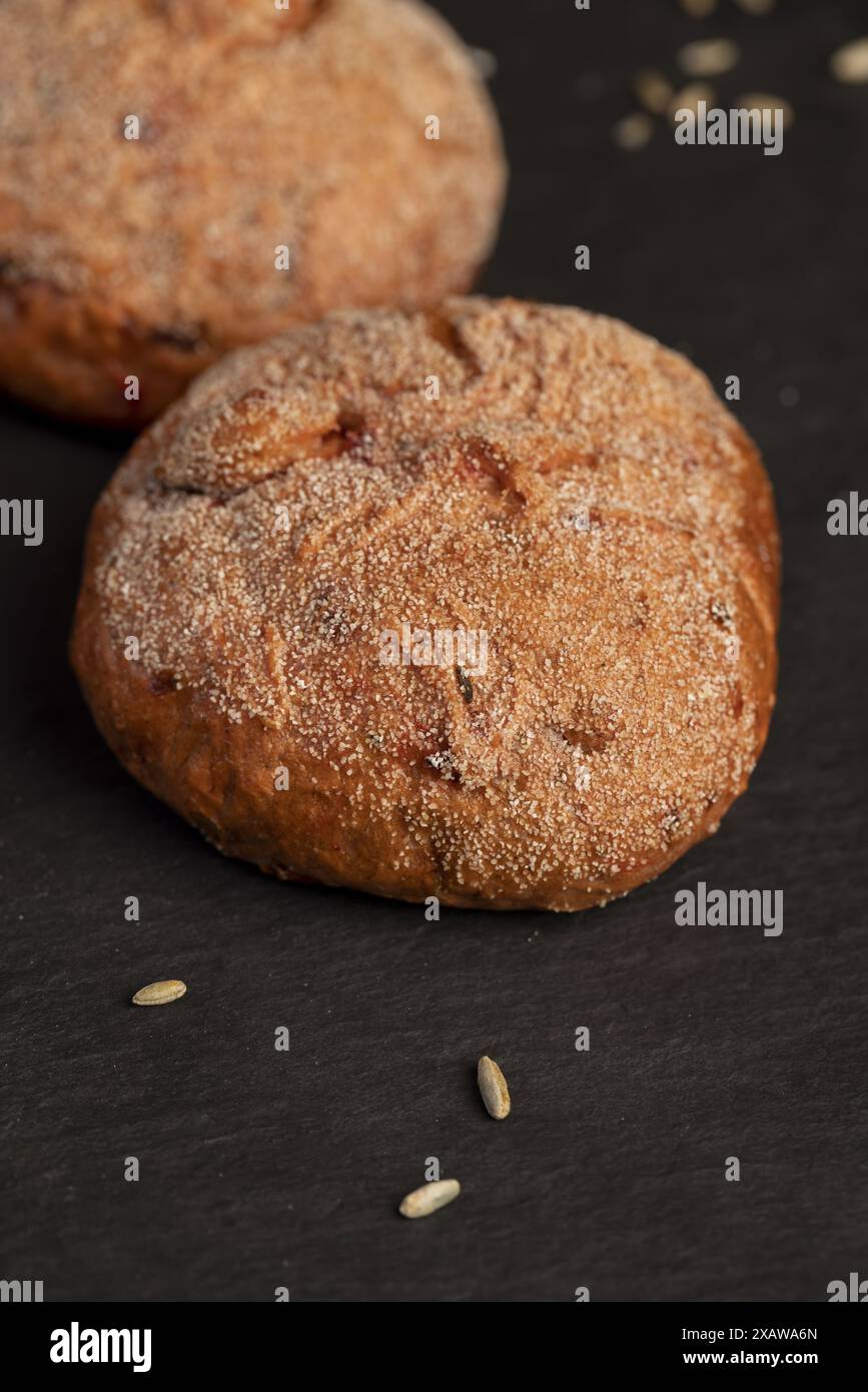 a fresh red round bun on the table, a red bun with the addition of red ...