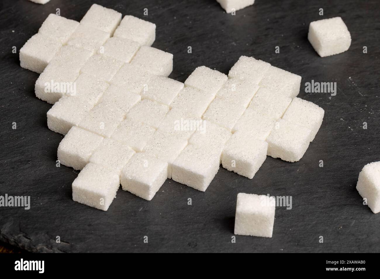 white square sugar on a black background , lump sugar in the shape of a ...