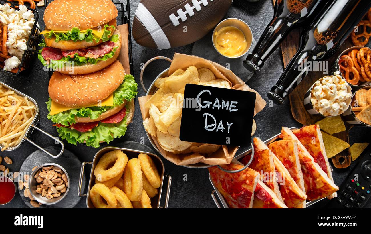 Selection of party food for watching football championship on a dark ...
