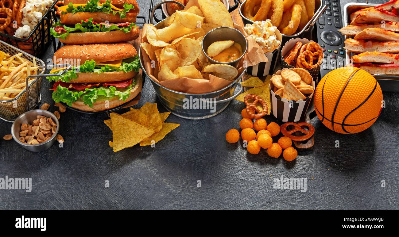 Selection of party food for watching football championship on a dark ...