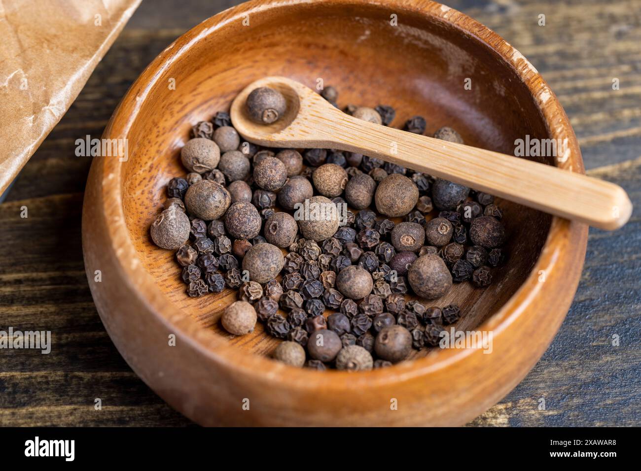 Round spices of black pepper and other peppers on the table, a mixture ...