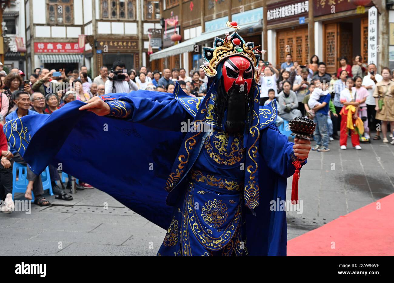 Tourists are watching Sichuan opera performers breathe fire at Dongxing ...