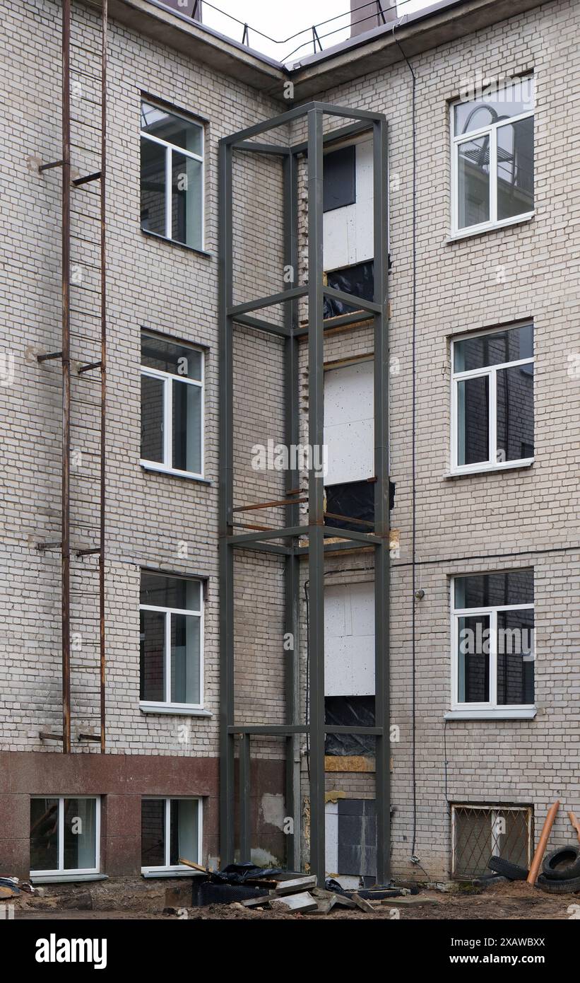Construction of an external elevator for the disabled in an old brick ...