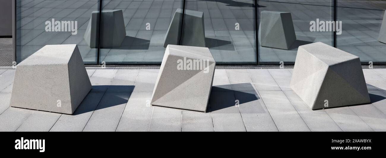 Concrete trapezoids decorate the facade of a modern office building ...