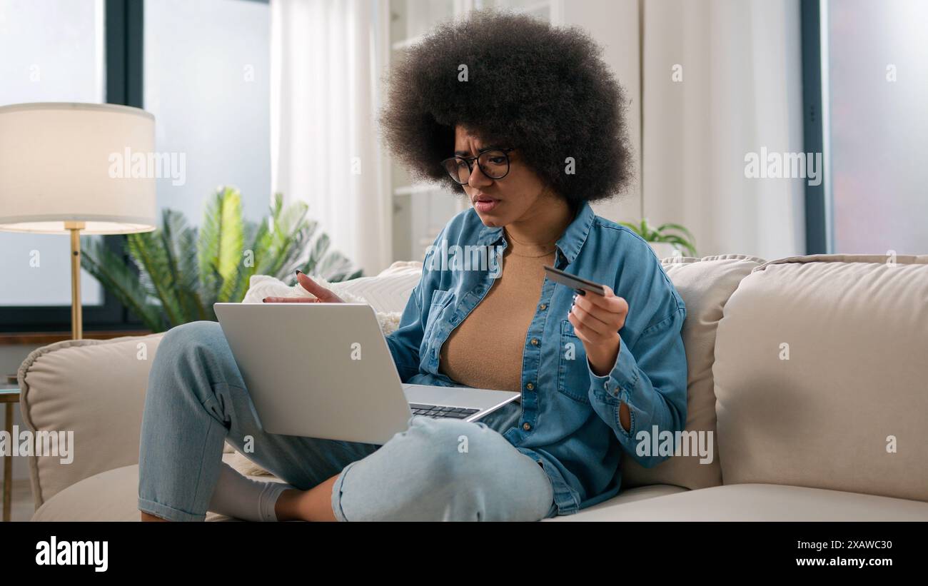 Confused puzzled irritated upset girl buyer African American woman try ...