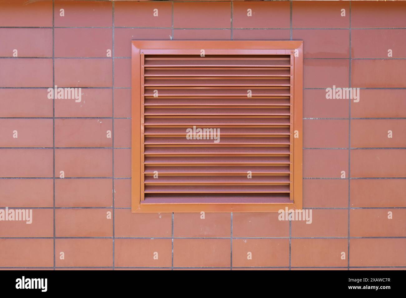 Steel ventilation grille in a red wall background Stock Photo - Alamy
