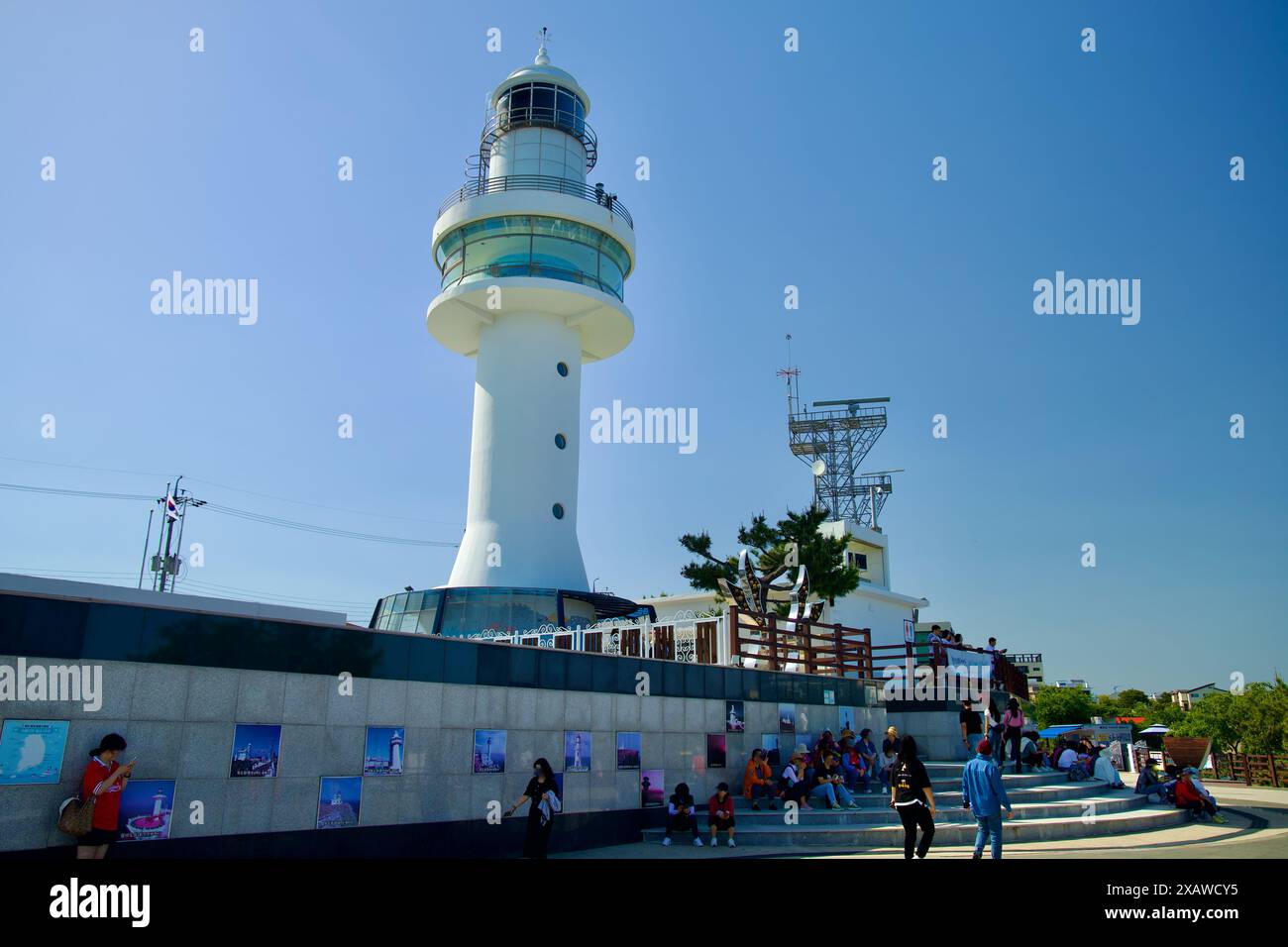 Donghae, South Korea - May 18, 2024: Visitors gather around Mukho Lighthouse, a prominent ...