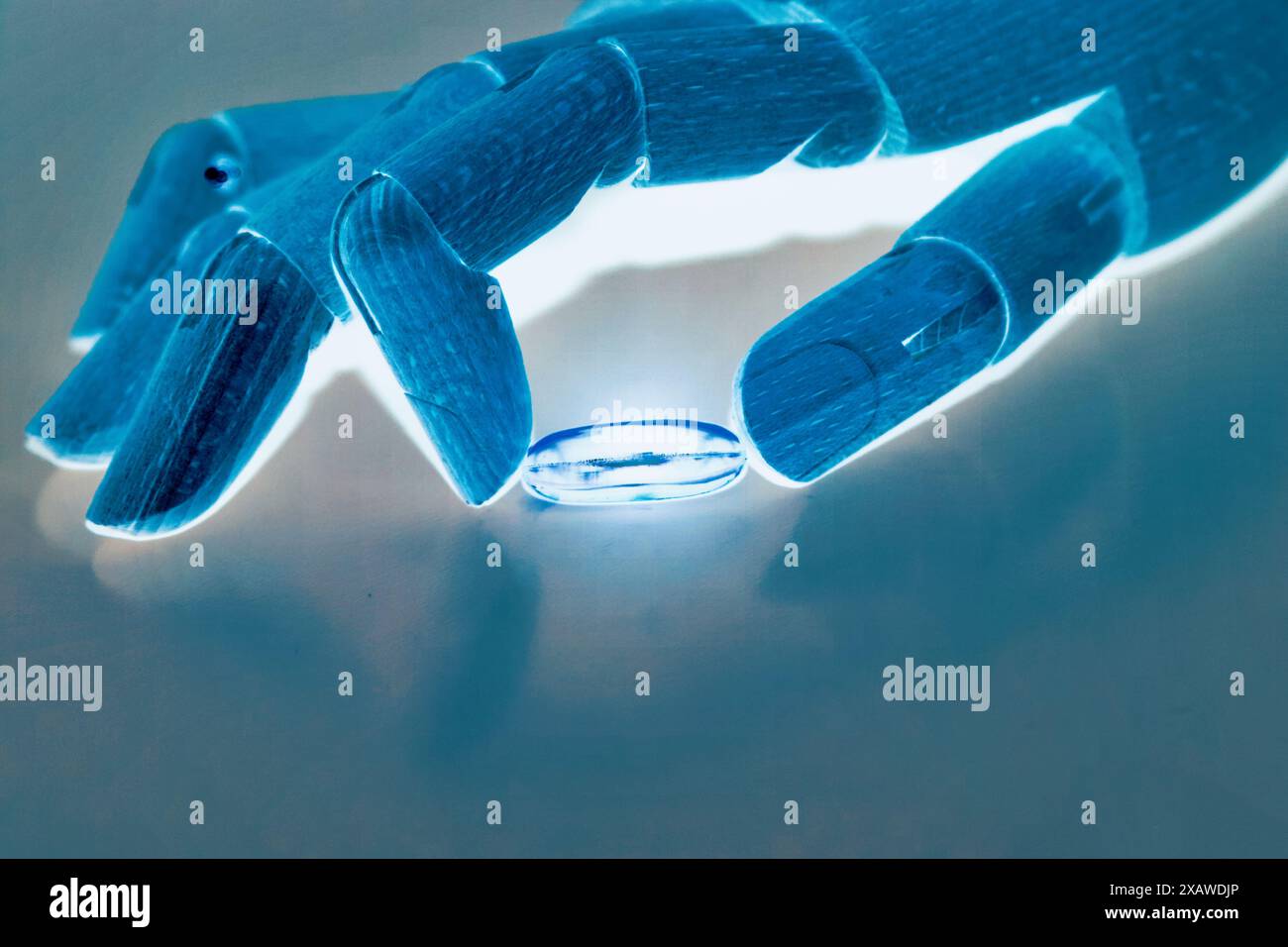 Robotic hand holds a futuristic pill Stock Photo - Alamy