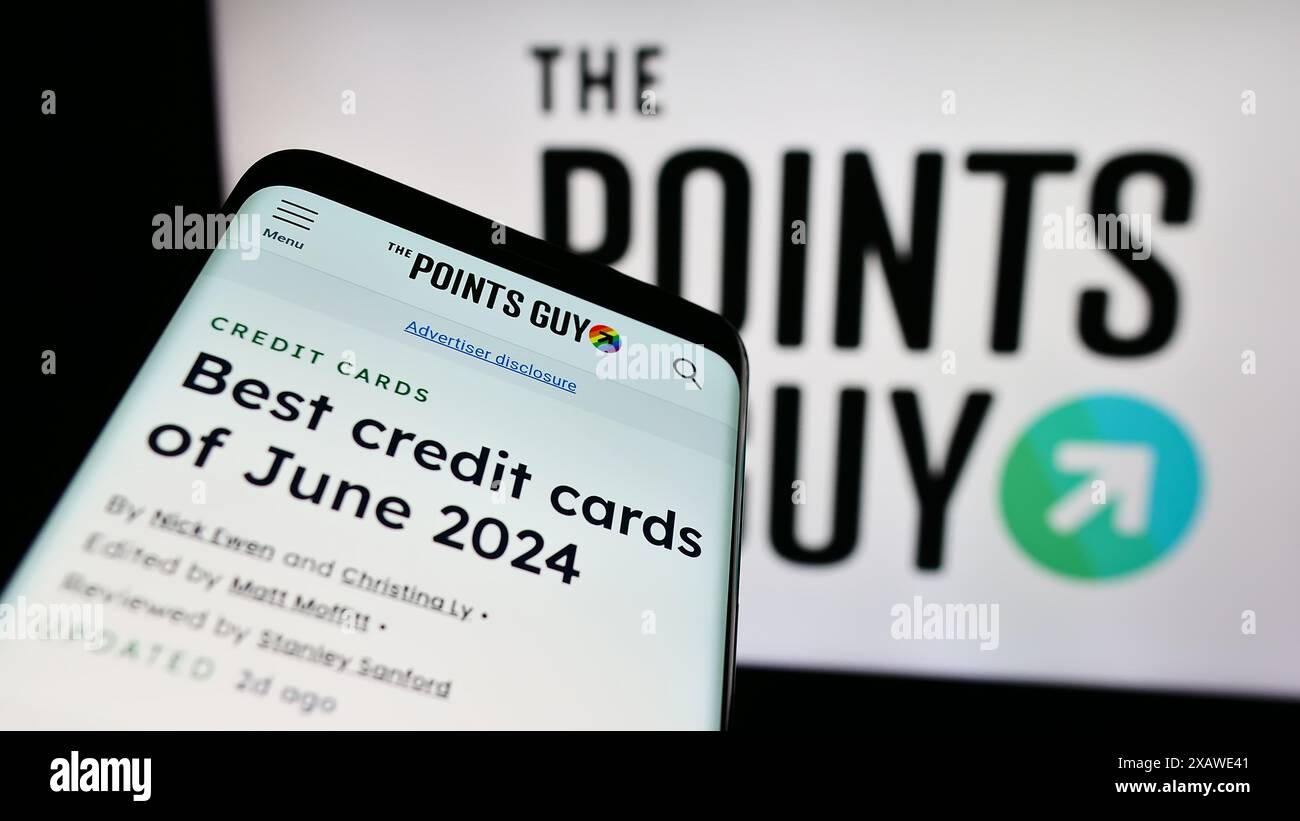 Mobile phone with website of US travel media company The Points Guy in ...