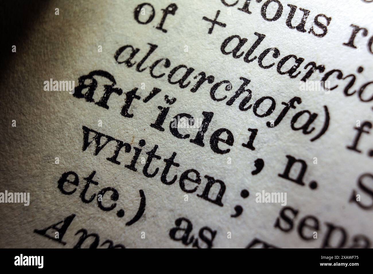 Word article on dictionary page, macro close-up Stock Photo - Alamy