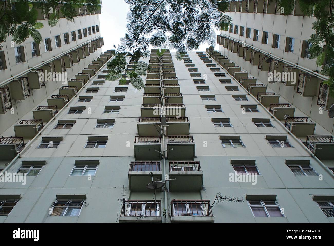 A tall apartment building with an extreme viewpoint from below Stock ...