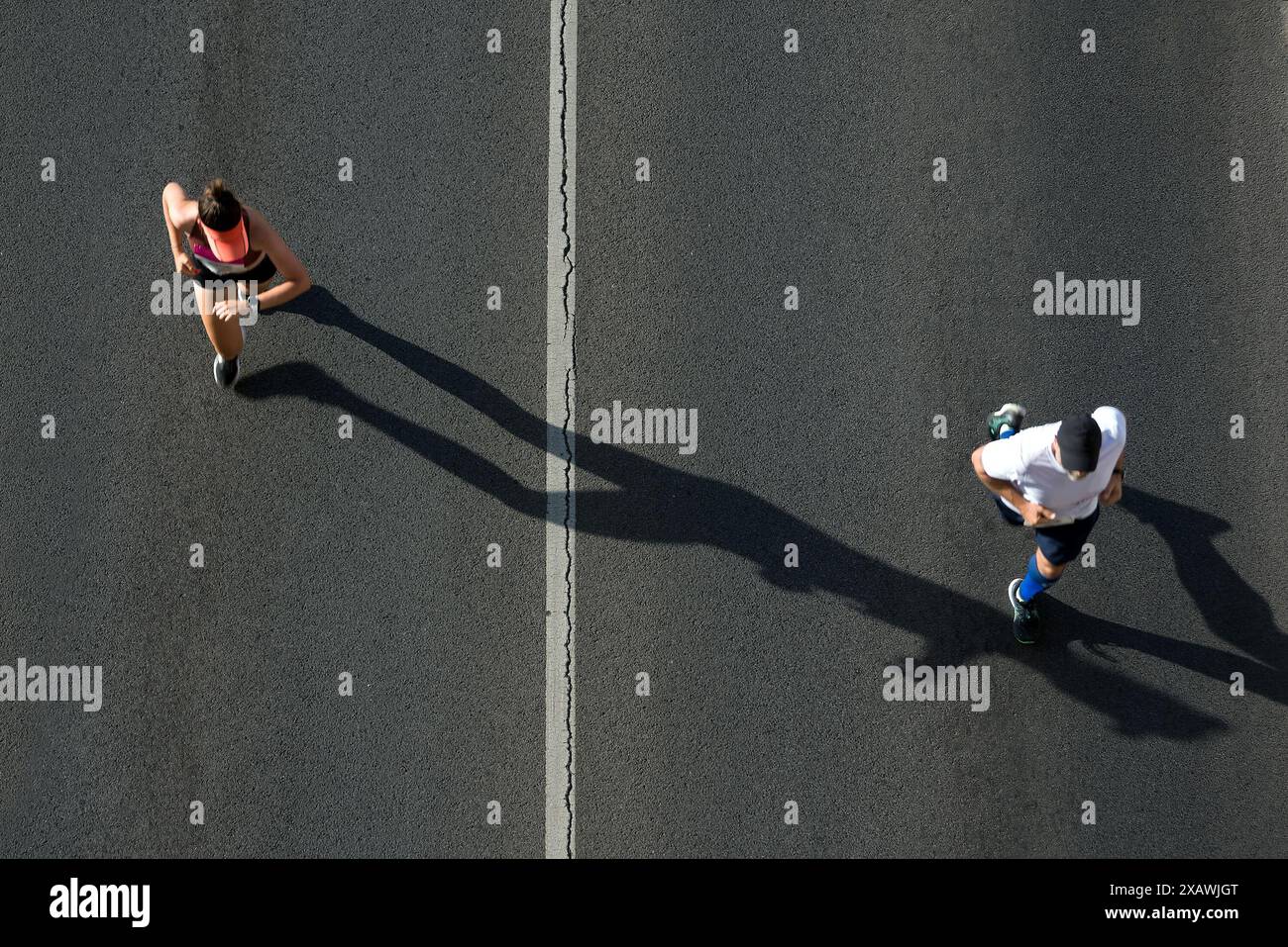 Competing male and female runners in motion, view from above Stock ...