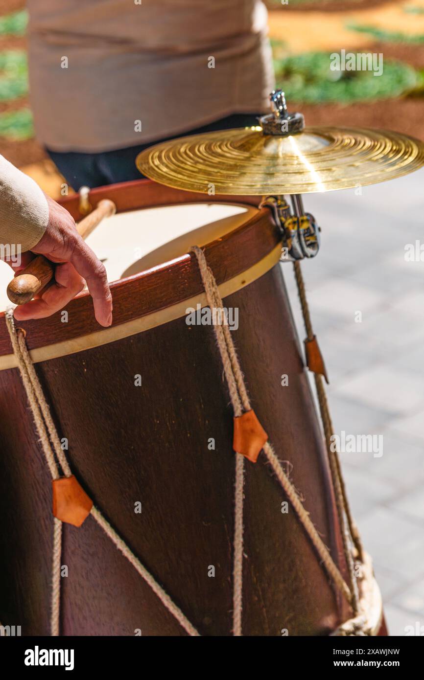 Detail of hands holding drumsticks playing timpani and cymbal drums in ...