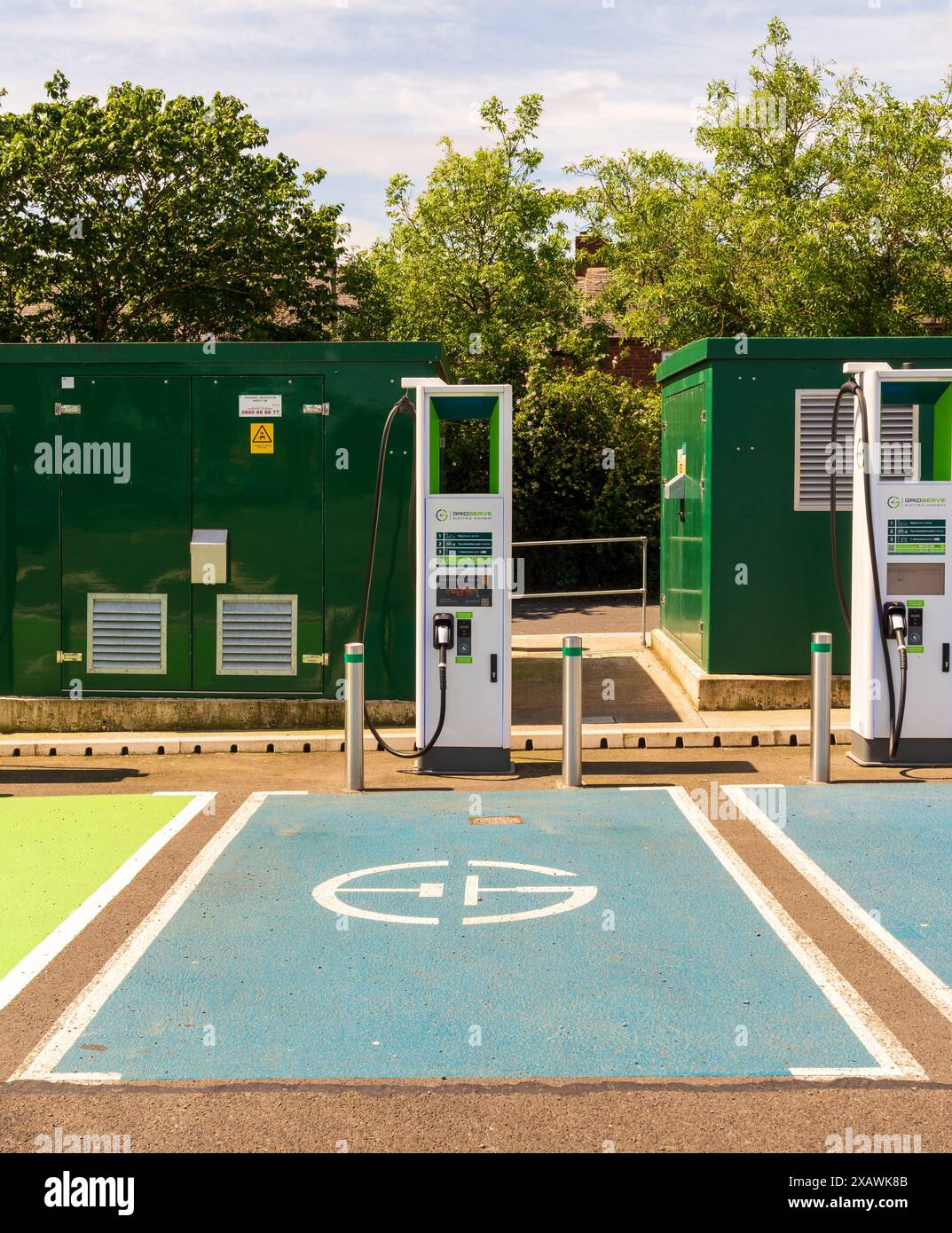 A Gridserve electric vehicle charging point with parking bay and signage Stock Photo - Alamy