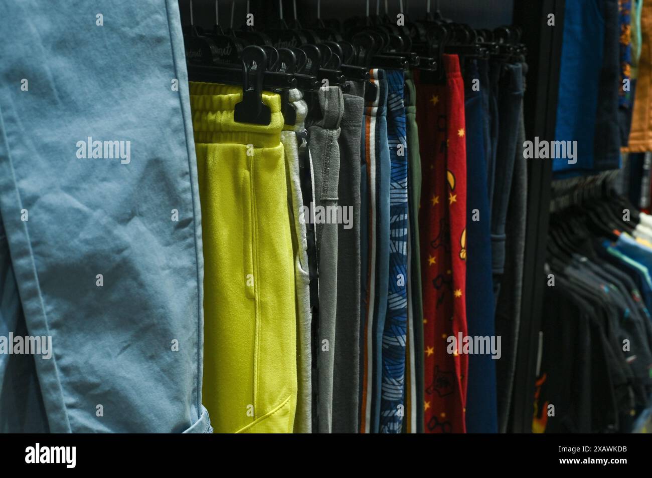 Pants hanging on hangers hi-res stock photography and images - Alamy