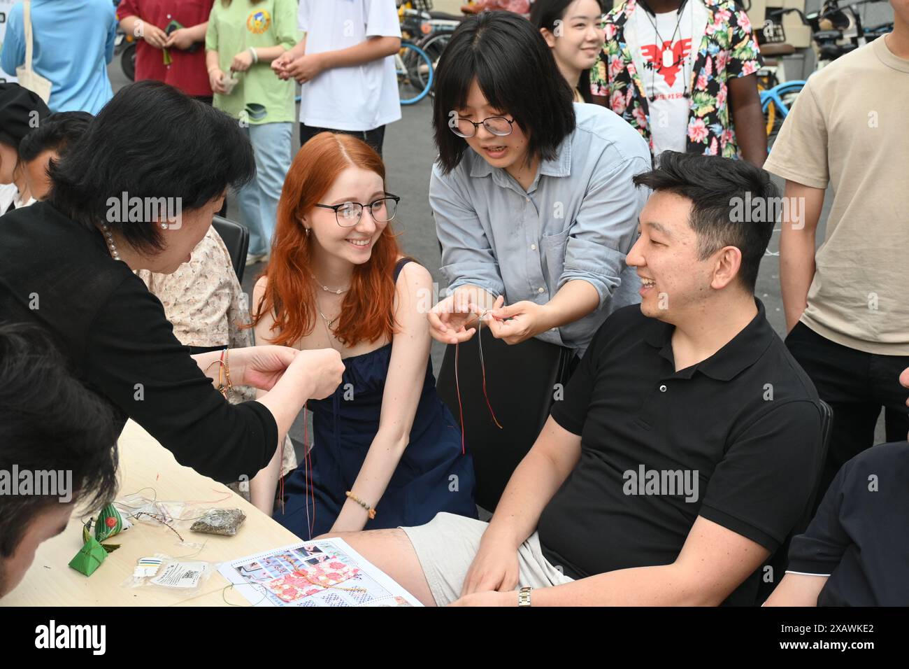 Tianjin. 9th June, 2024. International students learn to weave five ...