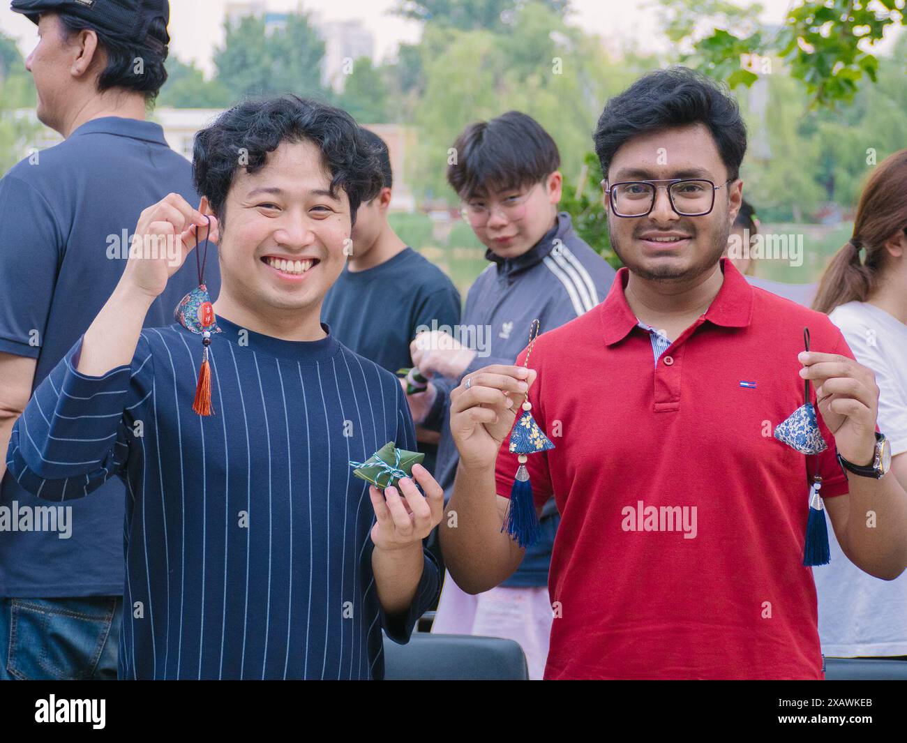 Tianjin. 9th June, 2024. International students display zongzi and ...
