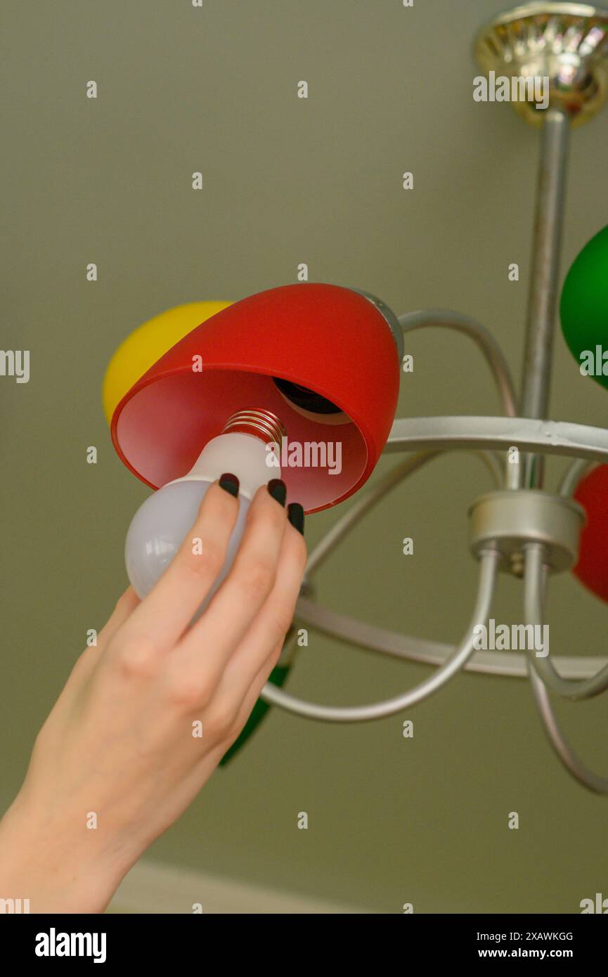 replacing the light bulb in the lamp Stock Photo - Alamy