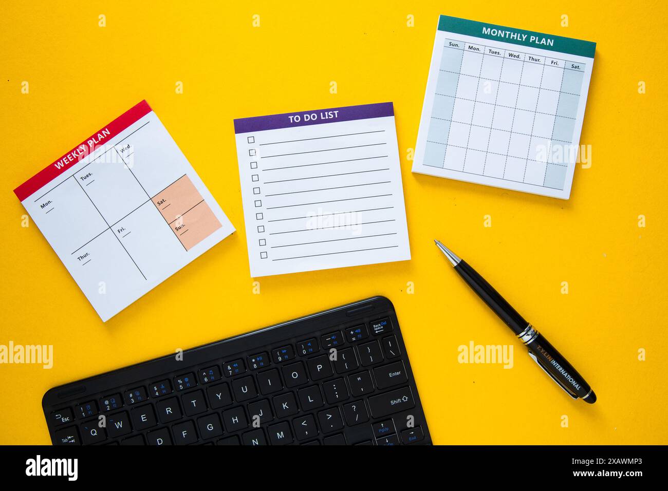 Manager organizing week using calendar, monthly planner and to do list ...