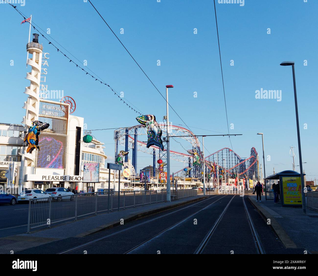Tram tracks and stop with the Pleasure Beach Roller Coasters behind in ...