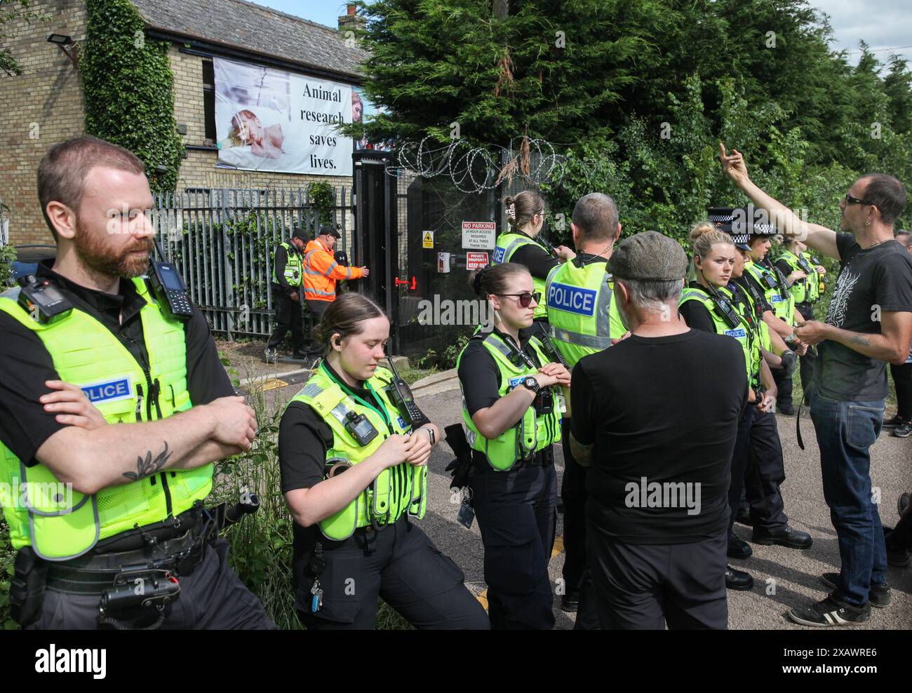 A protester shows an offensive hand gesture towards the workers in ...