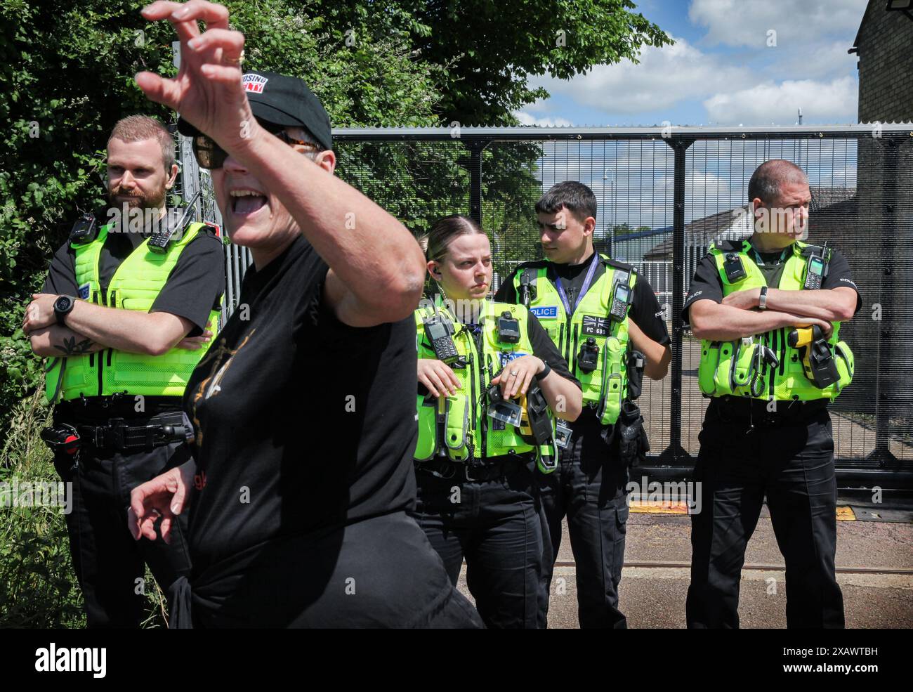 A protester shouts her message in front of the police cordon at the ...