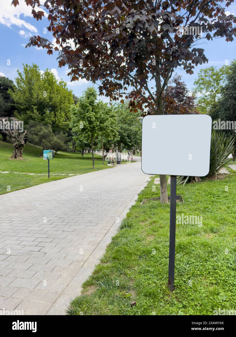 mockup, side view Empty or Blank White Signpost by path in park in ...