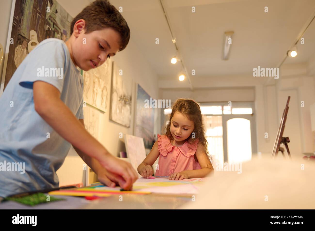 Kids have art class, drawing, painting with teacher in a workshop. They ...