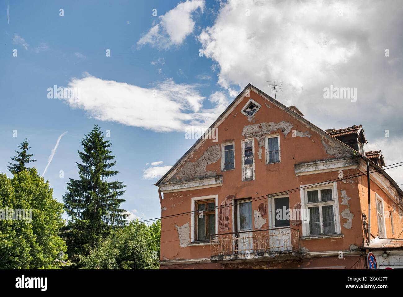 Old neglected and crumbling nice countryside town house on sunny day ...