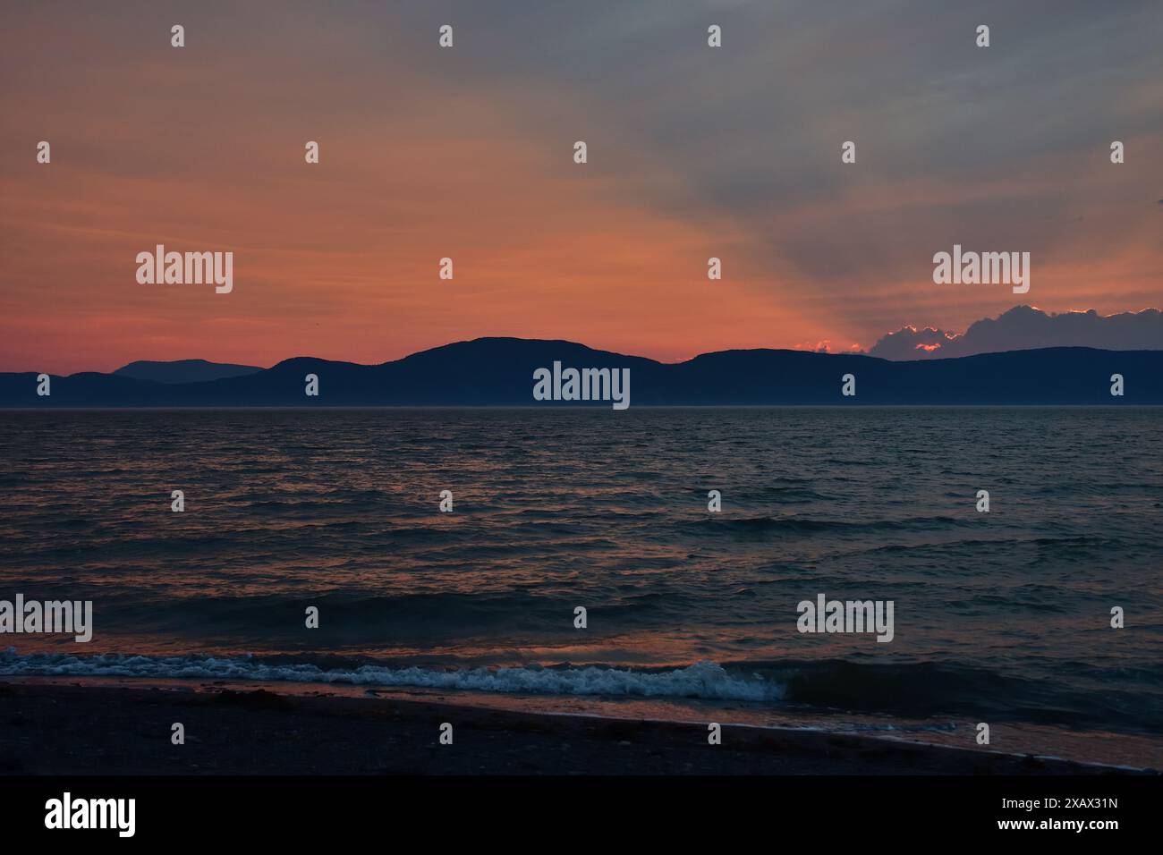 Sunset on St-Lawrence river at Ile aux Lievres. Sun ray flair above ...