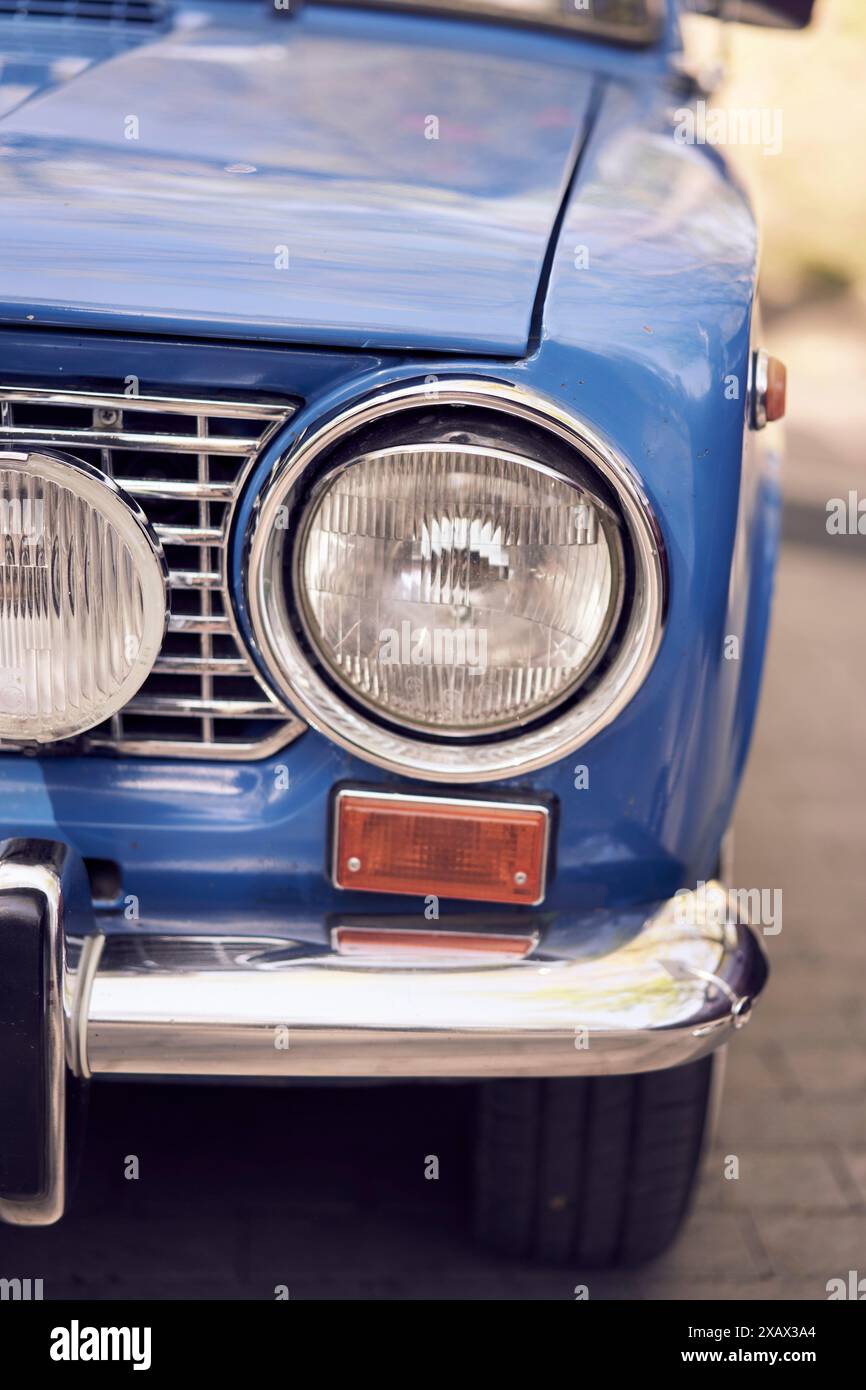 Detailed closeup view of a vintage classic car headlight featuring a ...
