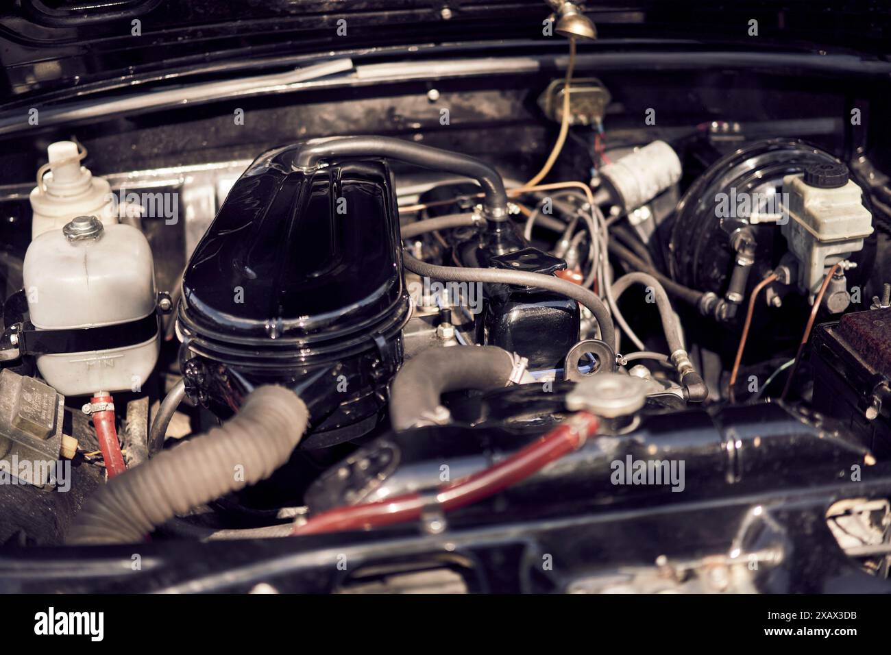 Detailed view of an old classic car engine with various parts and ...