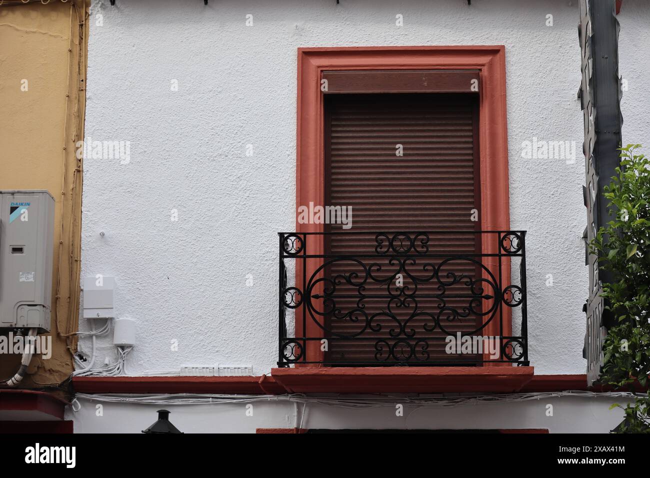 Windows with steel lattice on a whitewashed wall. Andalusian white ...