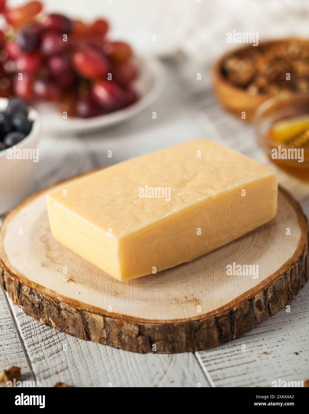 Tilsiter cheese block on chopped wood podium in kitchen Stock Photo - Alamy