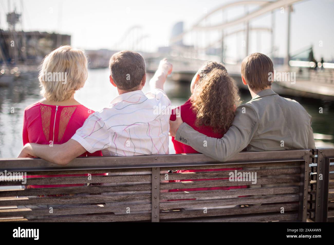 Tourists sitting on bench in port in European city Stock Photo - Alamy