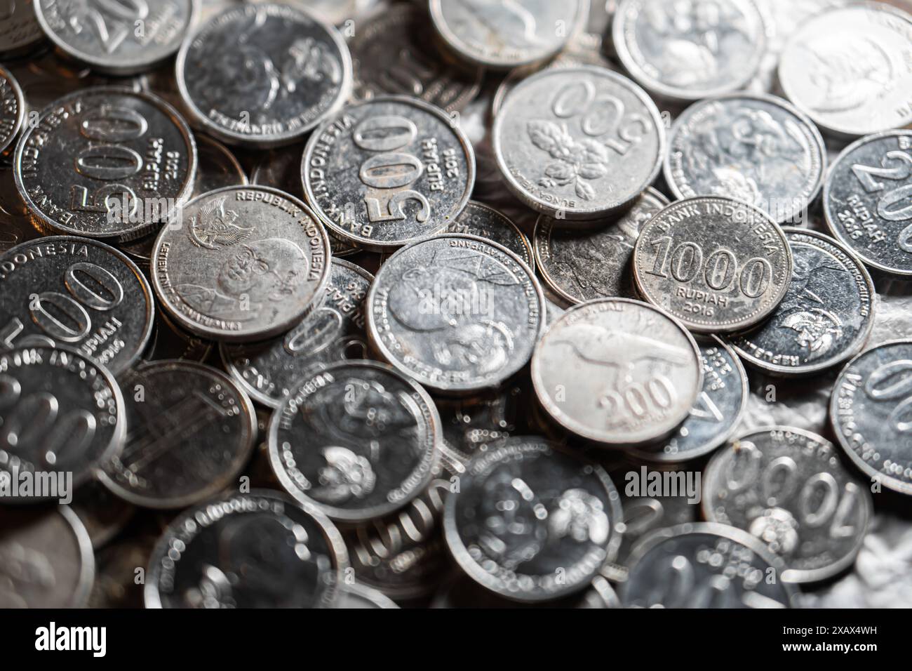 A close-up of various Indonesian Rupiah coins in different ...