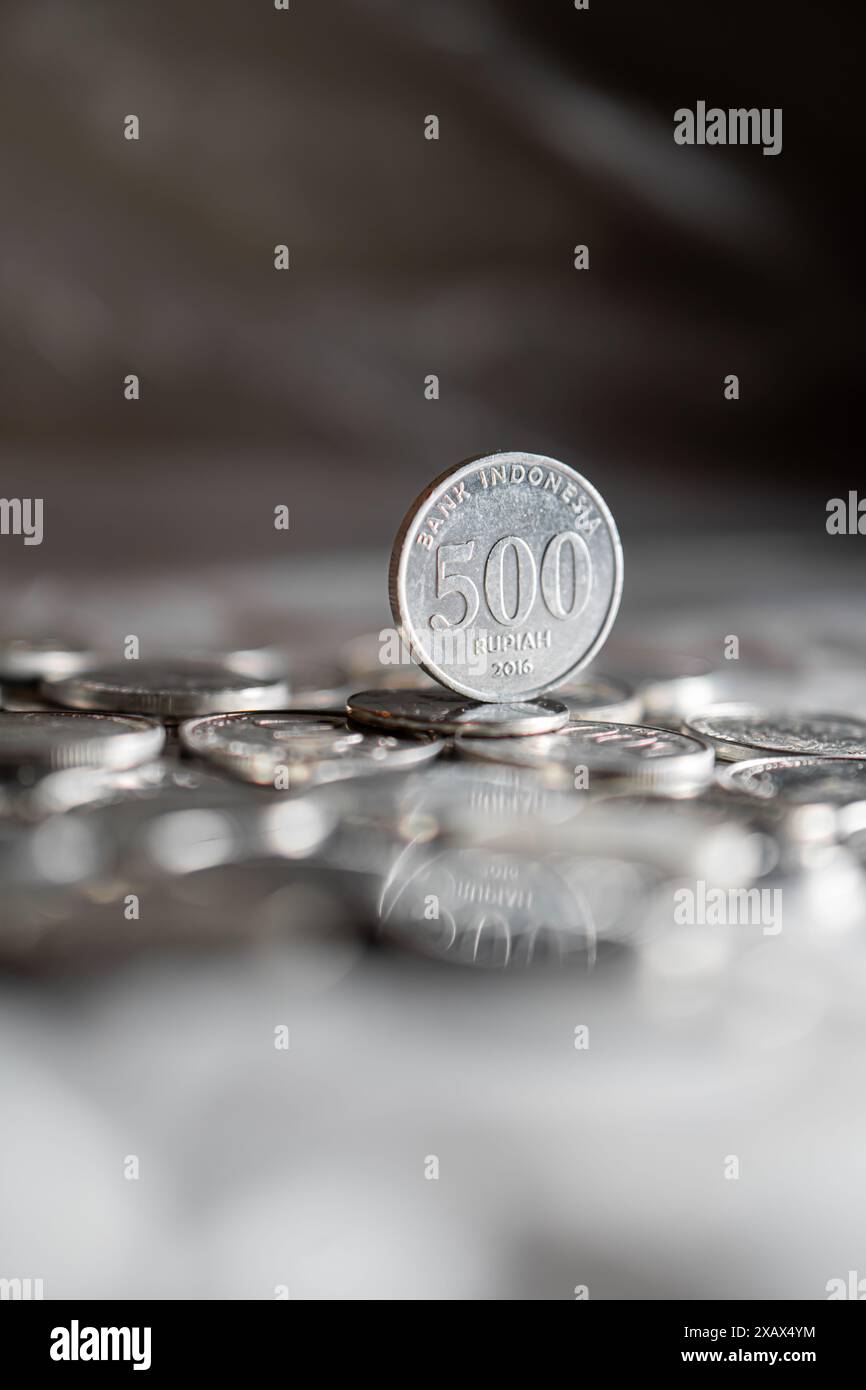 Close-up of Indonesian 500 Rupiah coins, with one coin standing upright ...