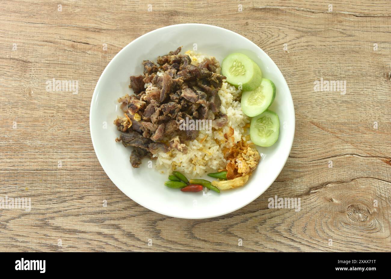 fried salty slice beef meat belly with crispy shallot and chili on rice ...