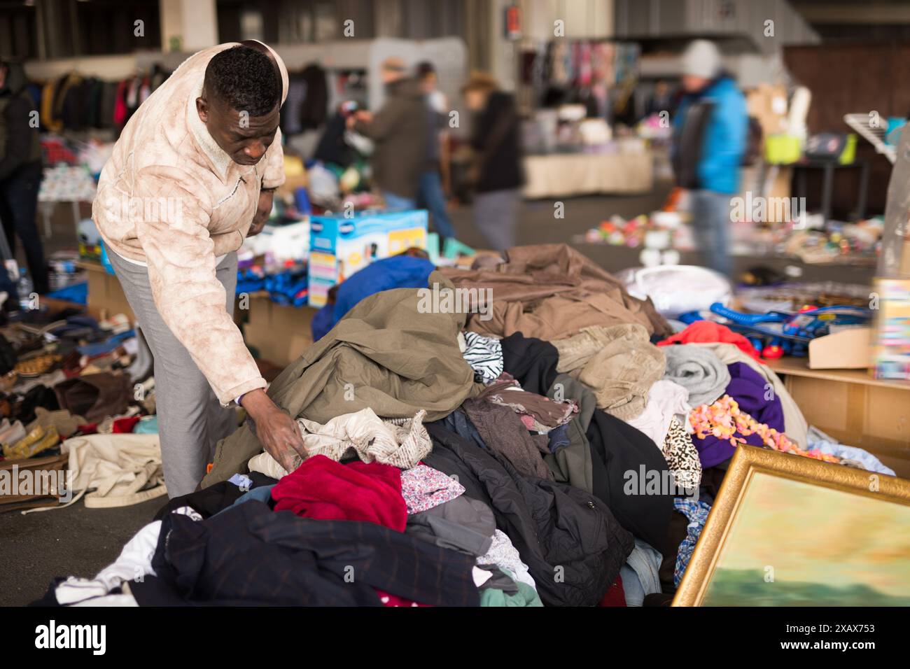 South African guy selects second-hand clothes at a flea market Stock ...