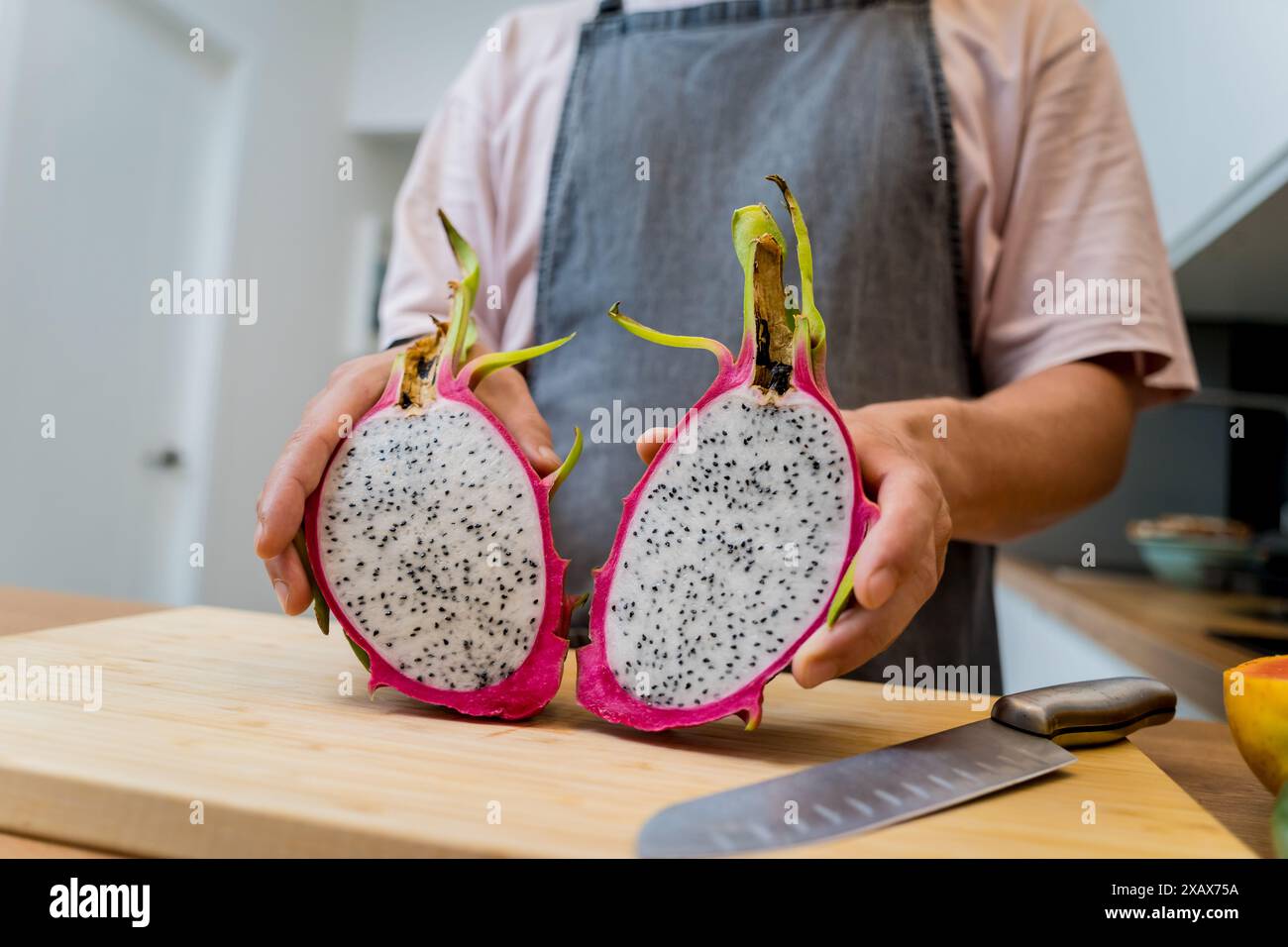 Chef cuts and peels dragon fruit on the cutting board Stock Photo - Alamy