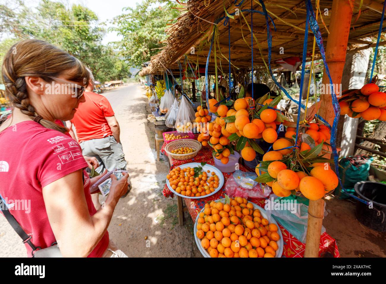 Roadside stall selling fruit, Laos Stock Photo - Alamy