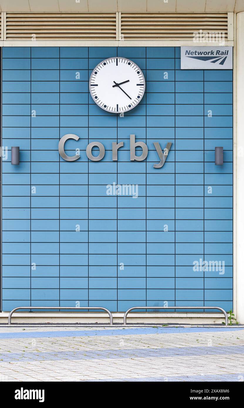 Clock on a wall of a ticket office at the railway station at Corby ...