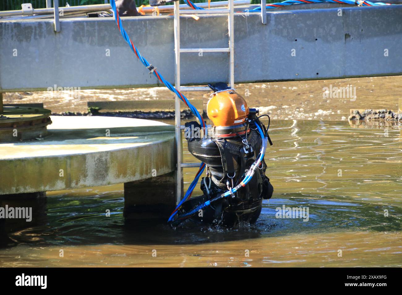 Diver climbs into the aeration tank in a sewage treatment plant Stock ...