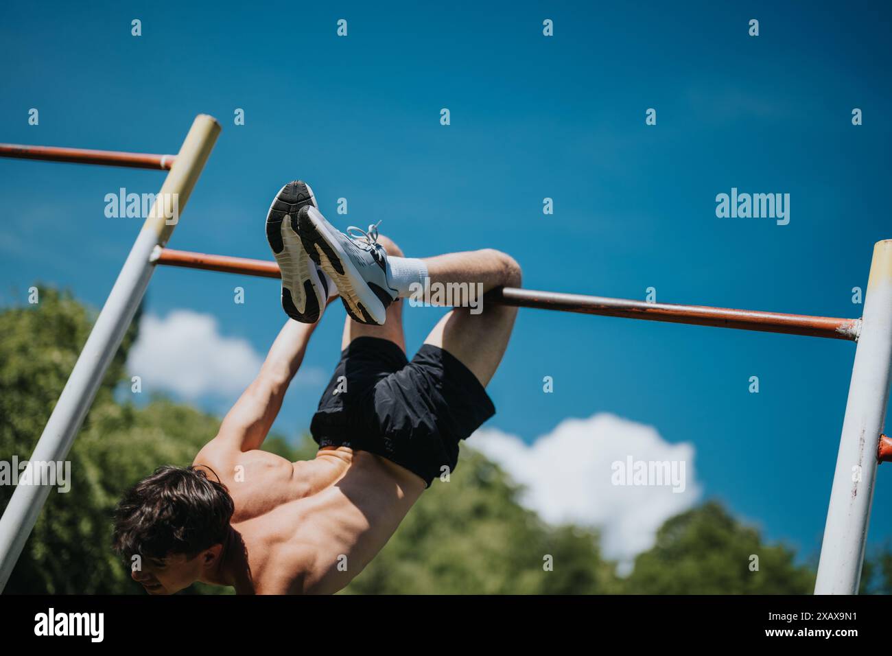 Muscular man performing hanging hi-res stock photography and images - Alamy