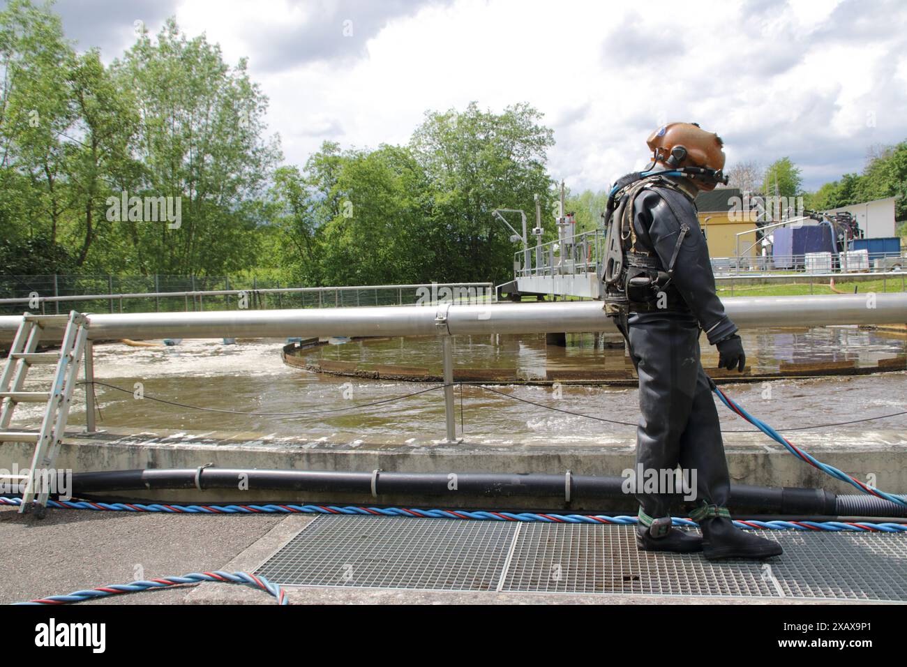 Diver climbs into the aeration tank in a sewage treatment plant Stock ...