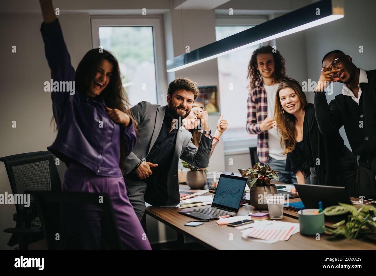 Energetic team celebrating a successful project in a modern office ...