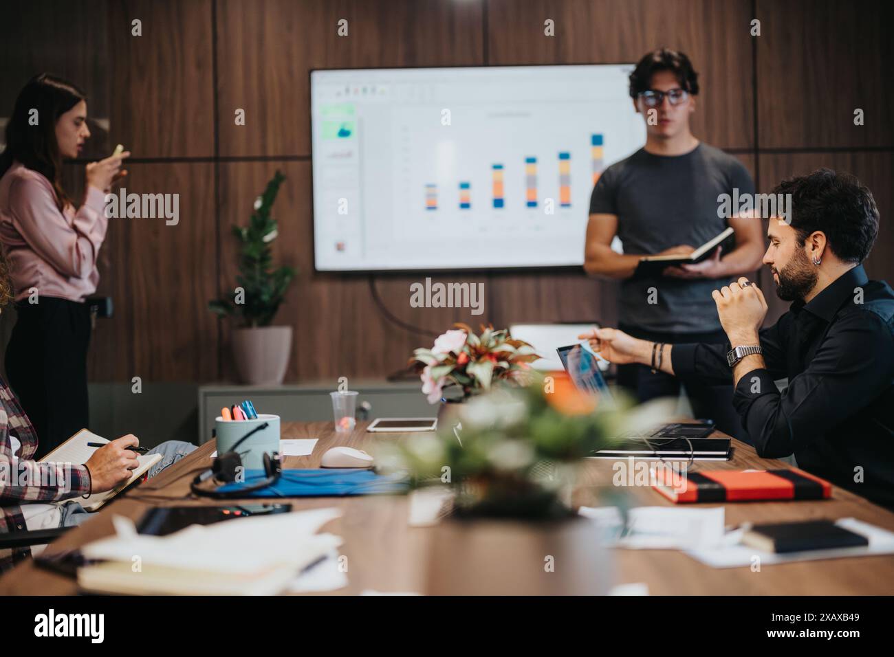 Business team engaging in a strategic meeting with digital projections ...